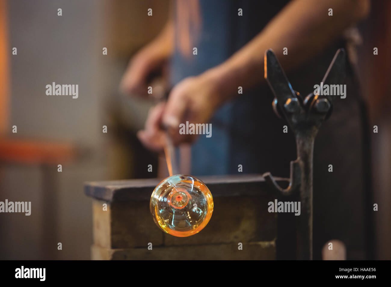 Glassblower shaping a molten glass Stock Photo - Alamy