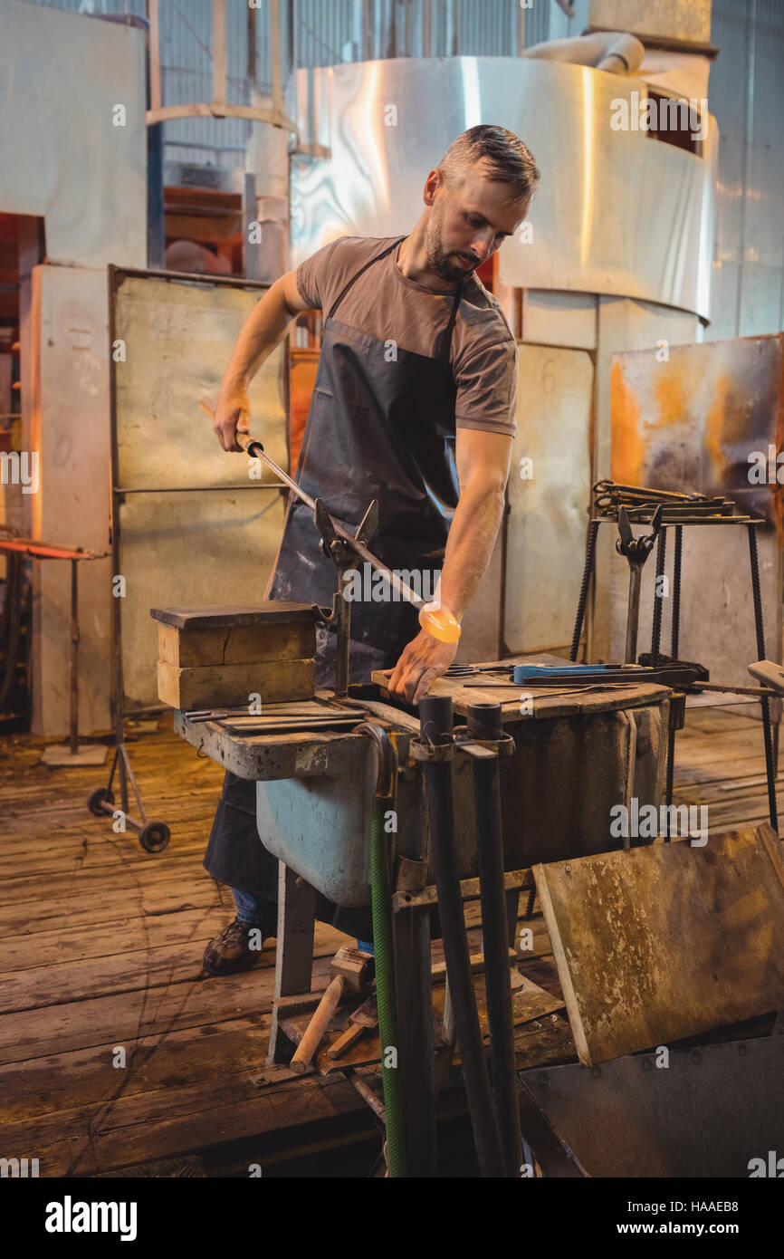 Glassblower shaping a molten glass Stock Photo - Alamy