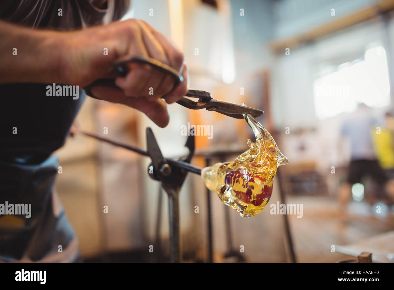 Glassblower shaping a molten glass Stock Photo - Alamy