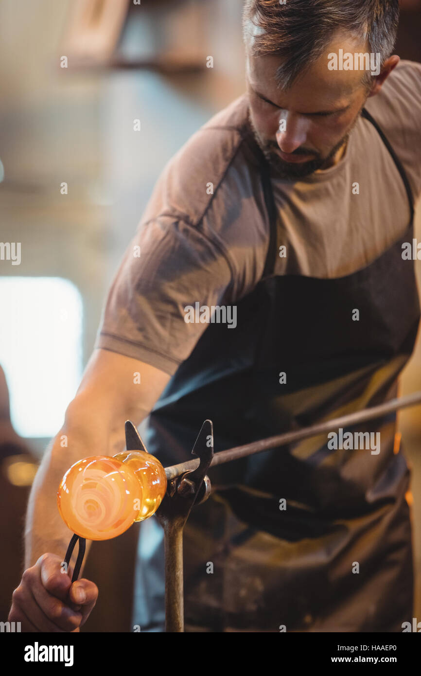 Glassblower shaping a molten glass Stock Photo - Alamy