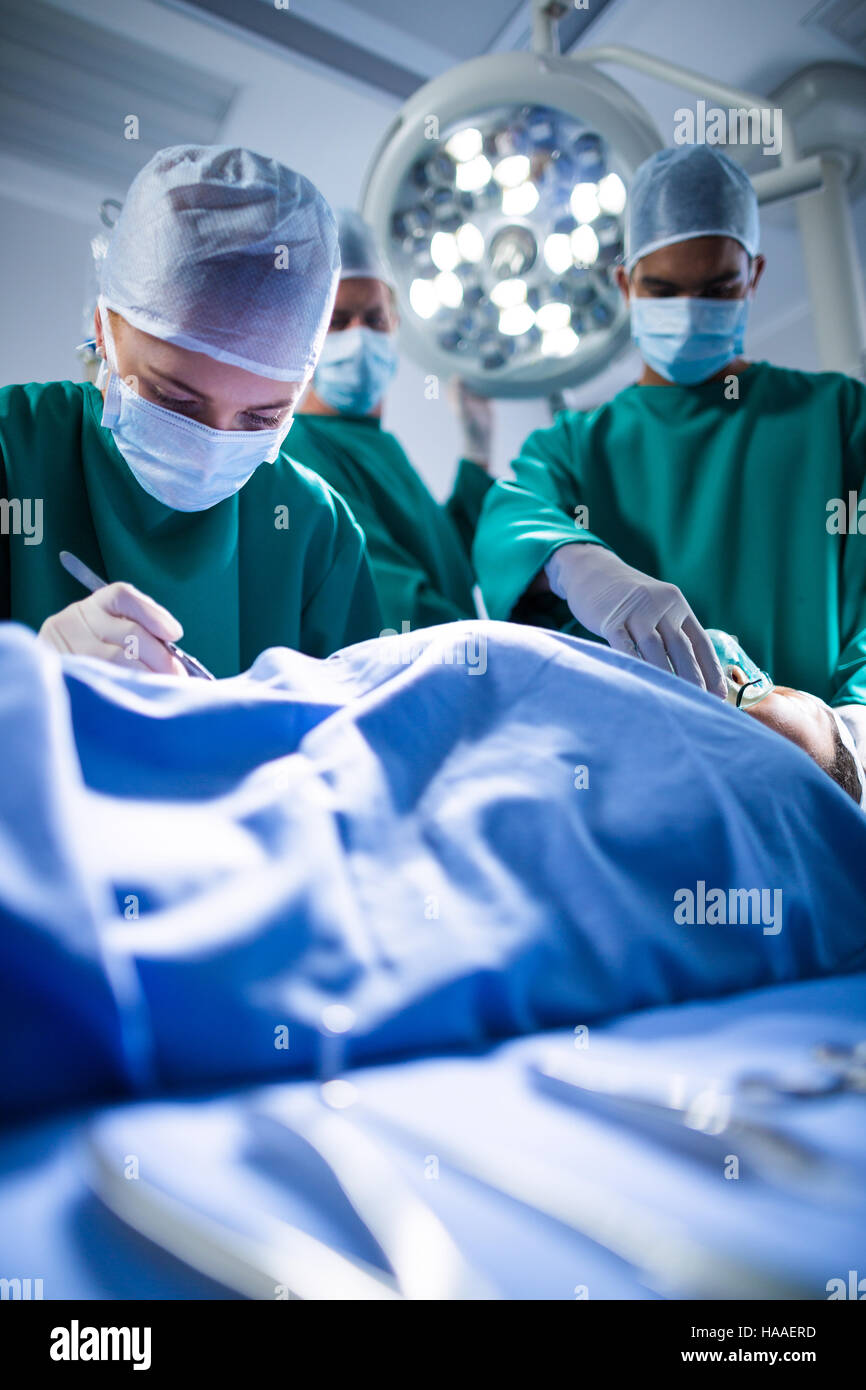 Surgeons performing operation in operation theater Stock Photo - Alamy