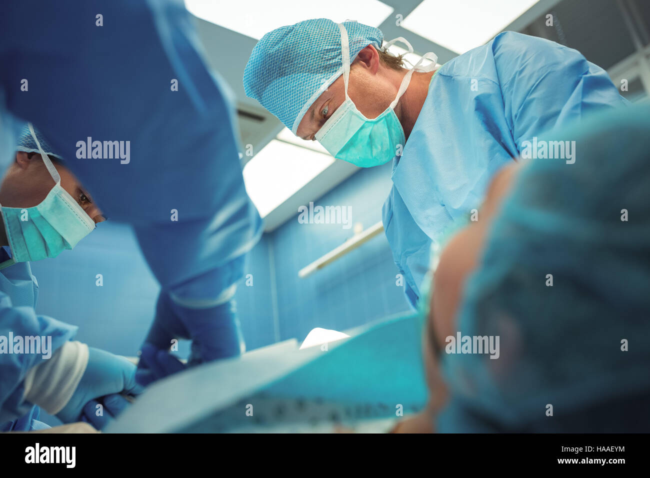 Team of surgeons performing operation in operation theater Stock Photo ...
