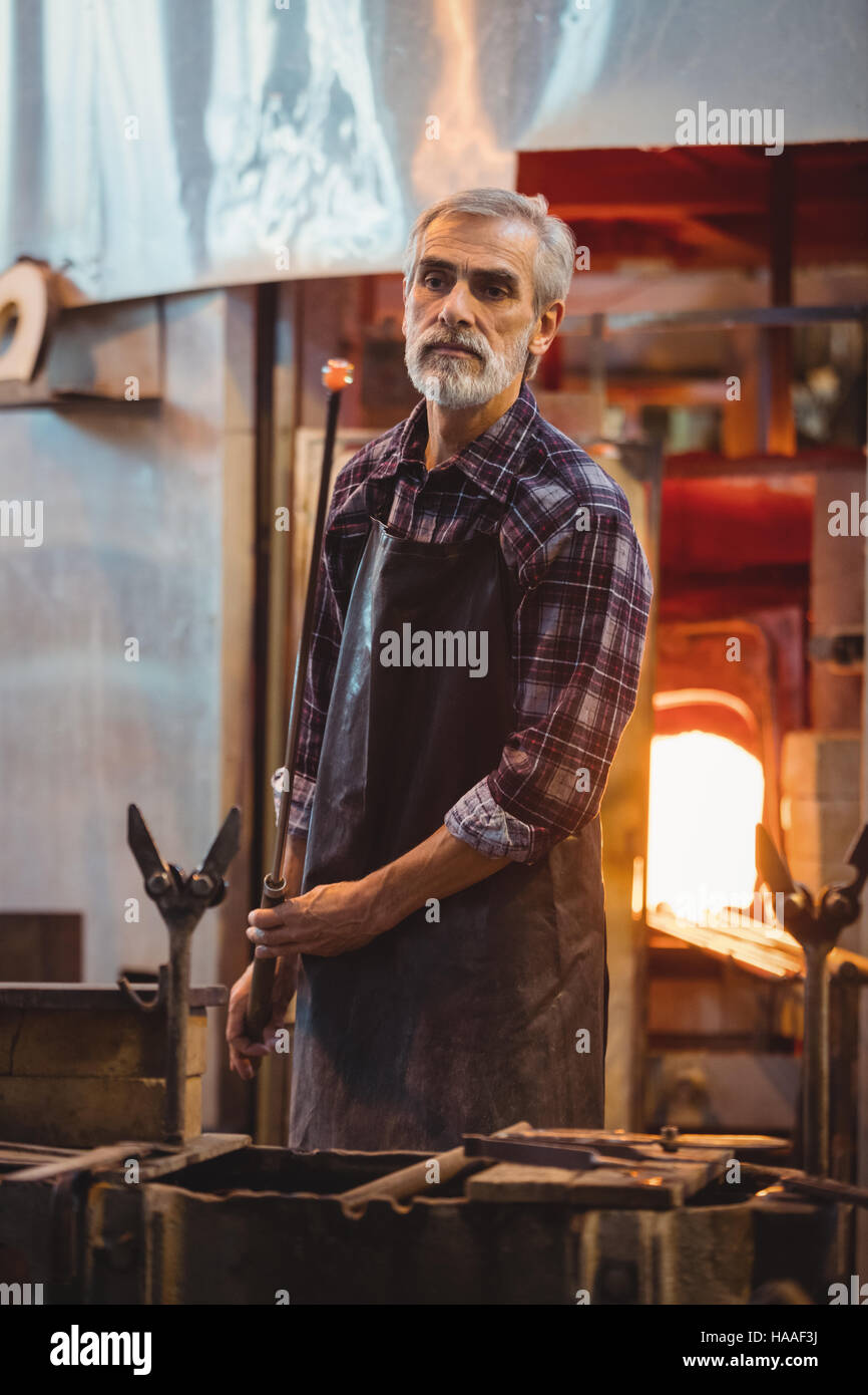 Glassblower shaping a molten glass Stock Photo - Alamy