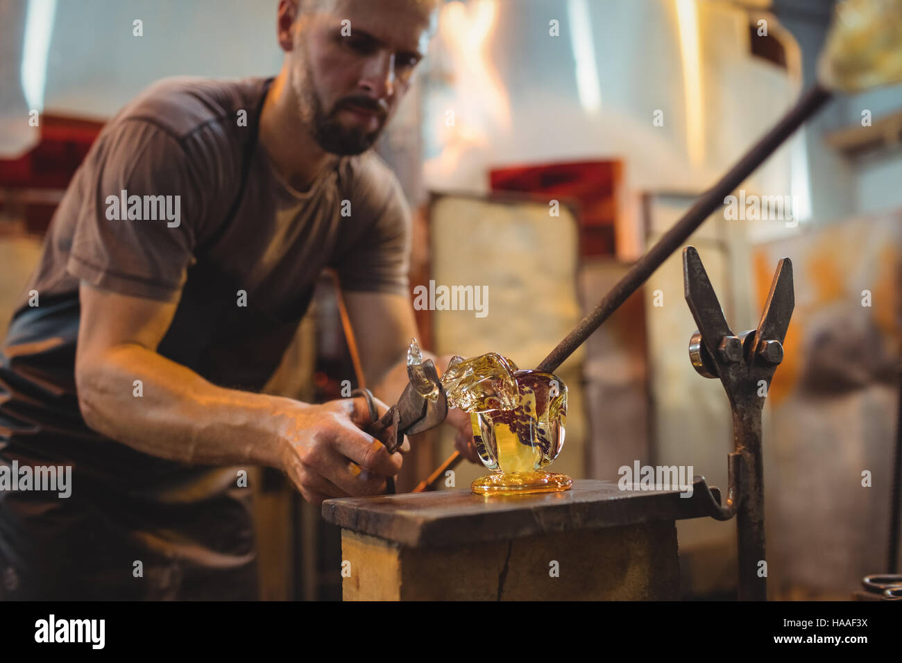 Glassblower shaping a molten glass Stock Photo - Alamy