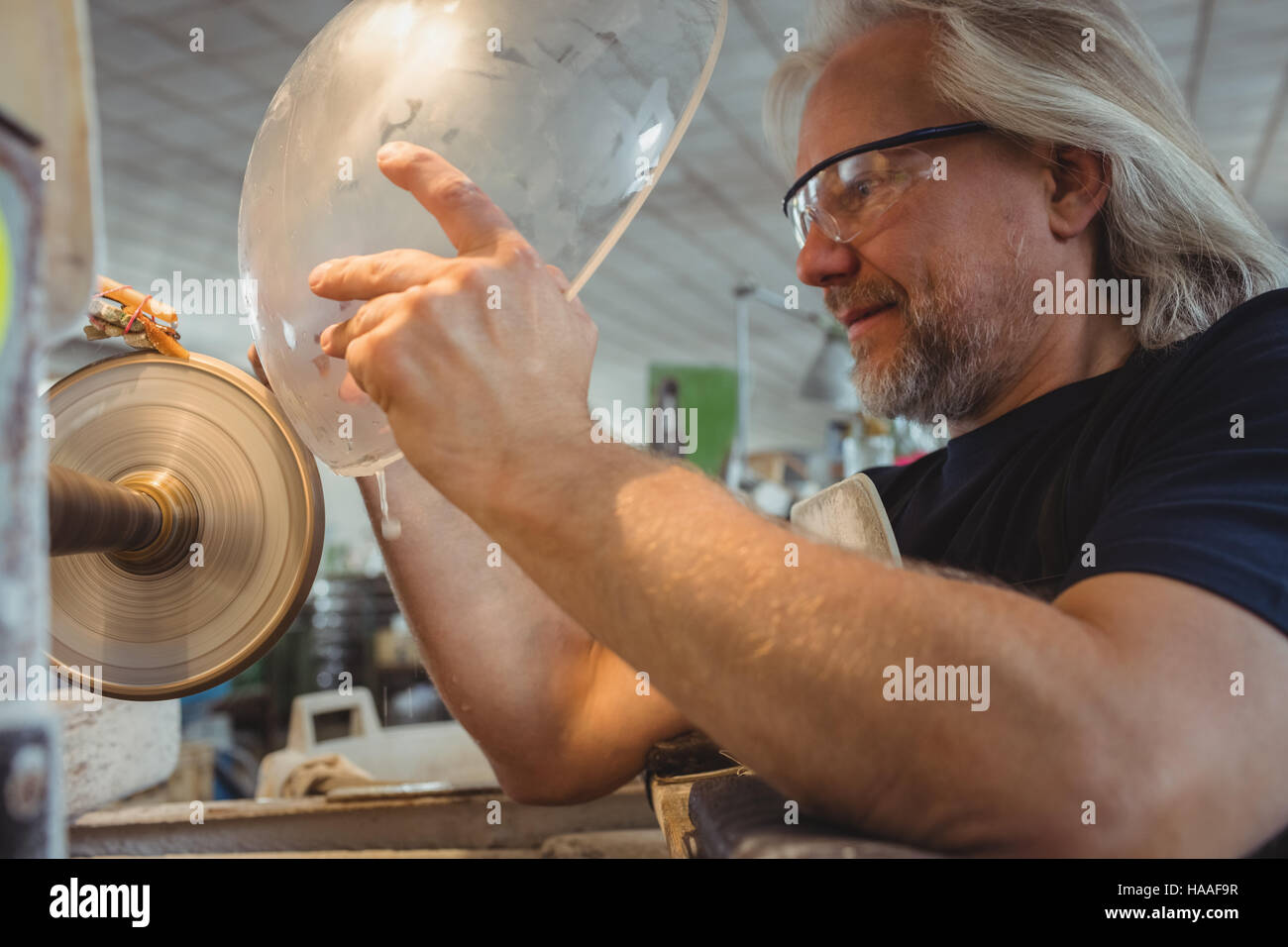 Glassblower polishing and grinding a glassware Stock Photo - Alamy