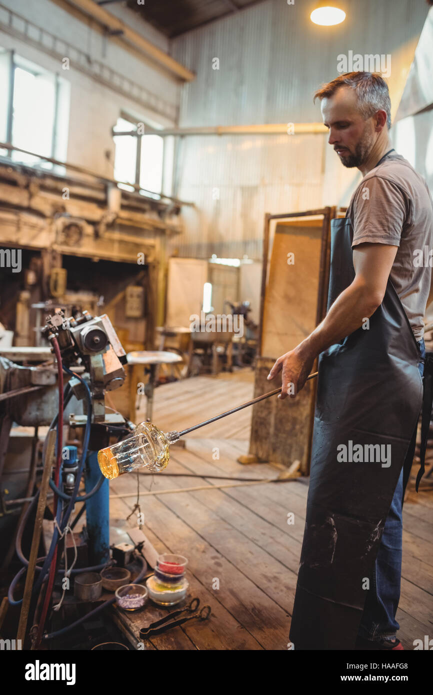 Glassblower shaping a molten glass Stock Photo - Alamy