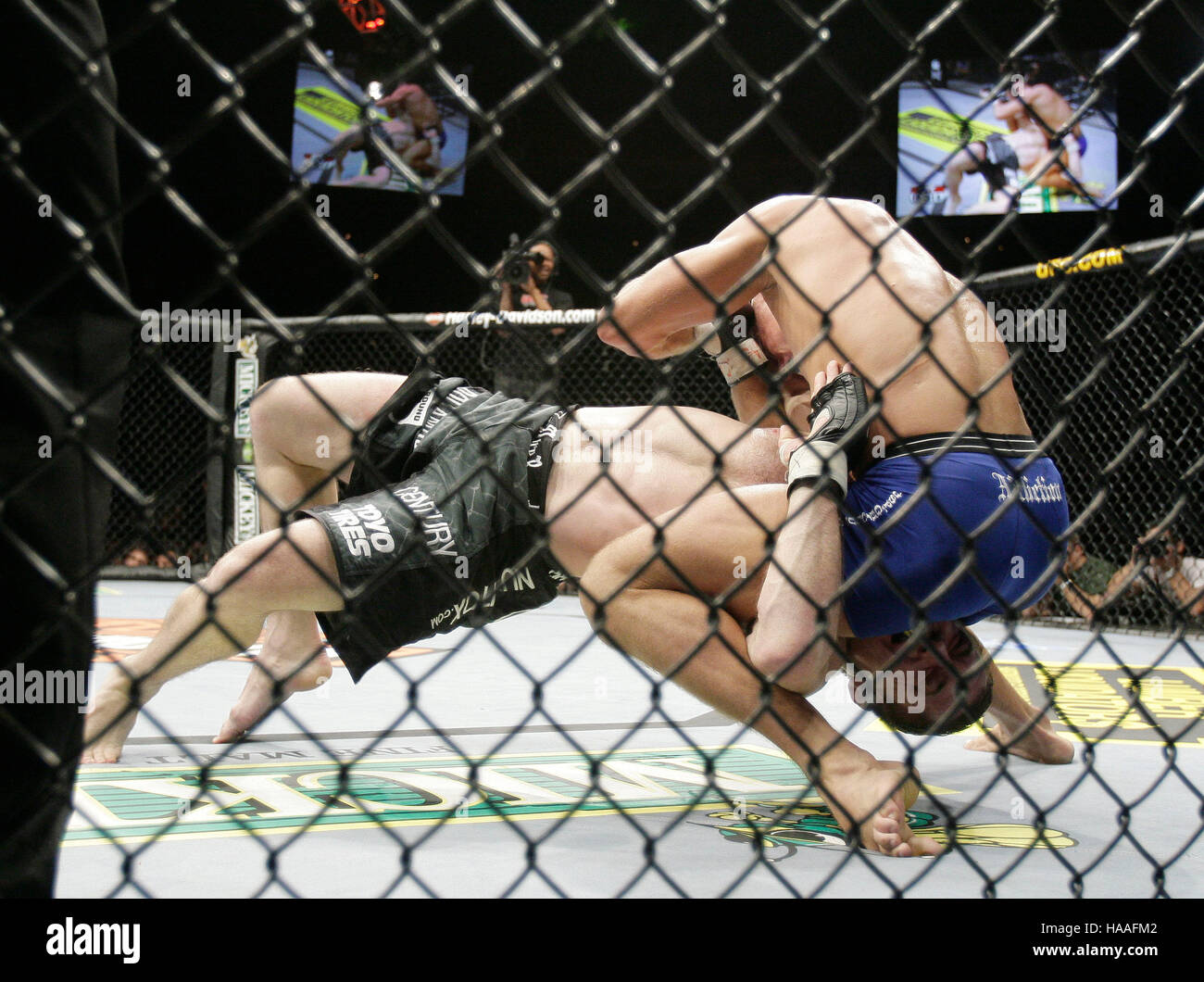 Georges St. Pierre right, submits Matt Hughes with an arm bar during ...