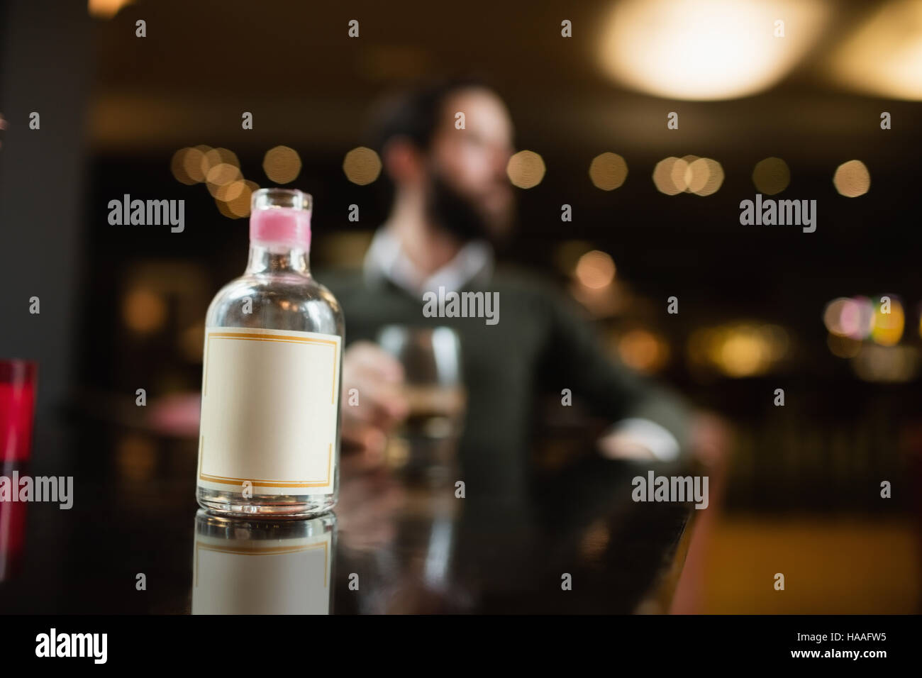Small liquor bottle on table Stock Photo - Alamy