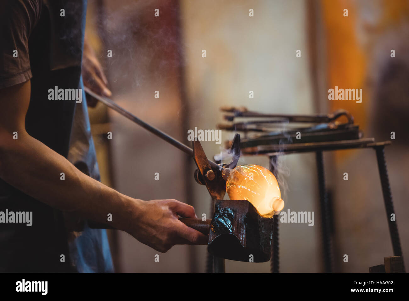 Glassblower forming and shaping a molten glass Stock Photo - Alamy