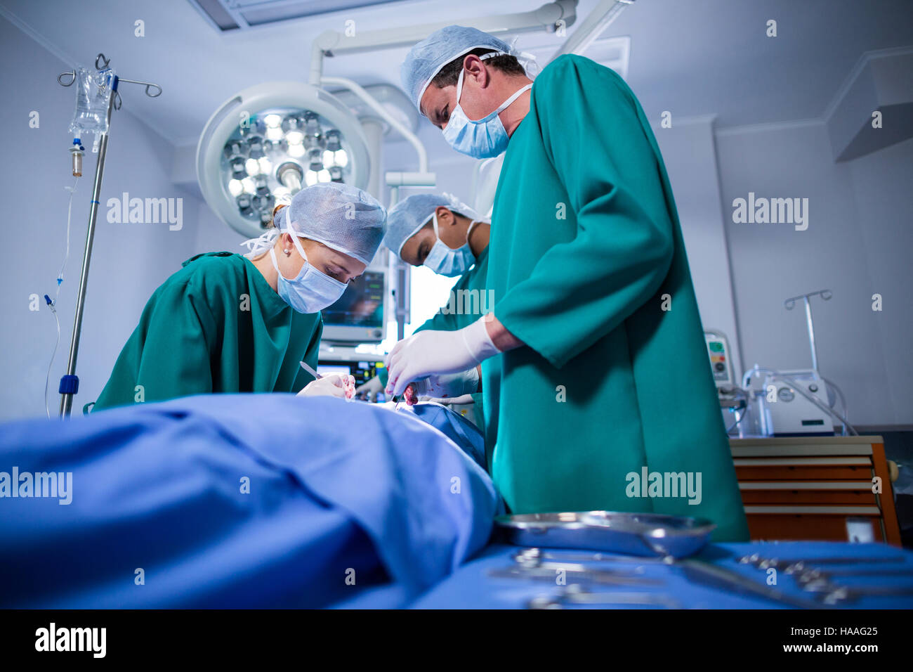 Surgeons performing operation in operation theater Stock Photo - Alamy