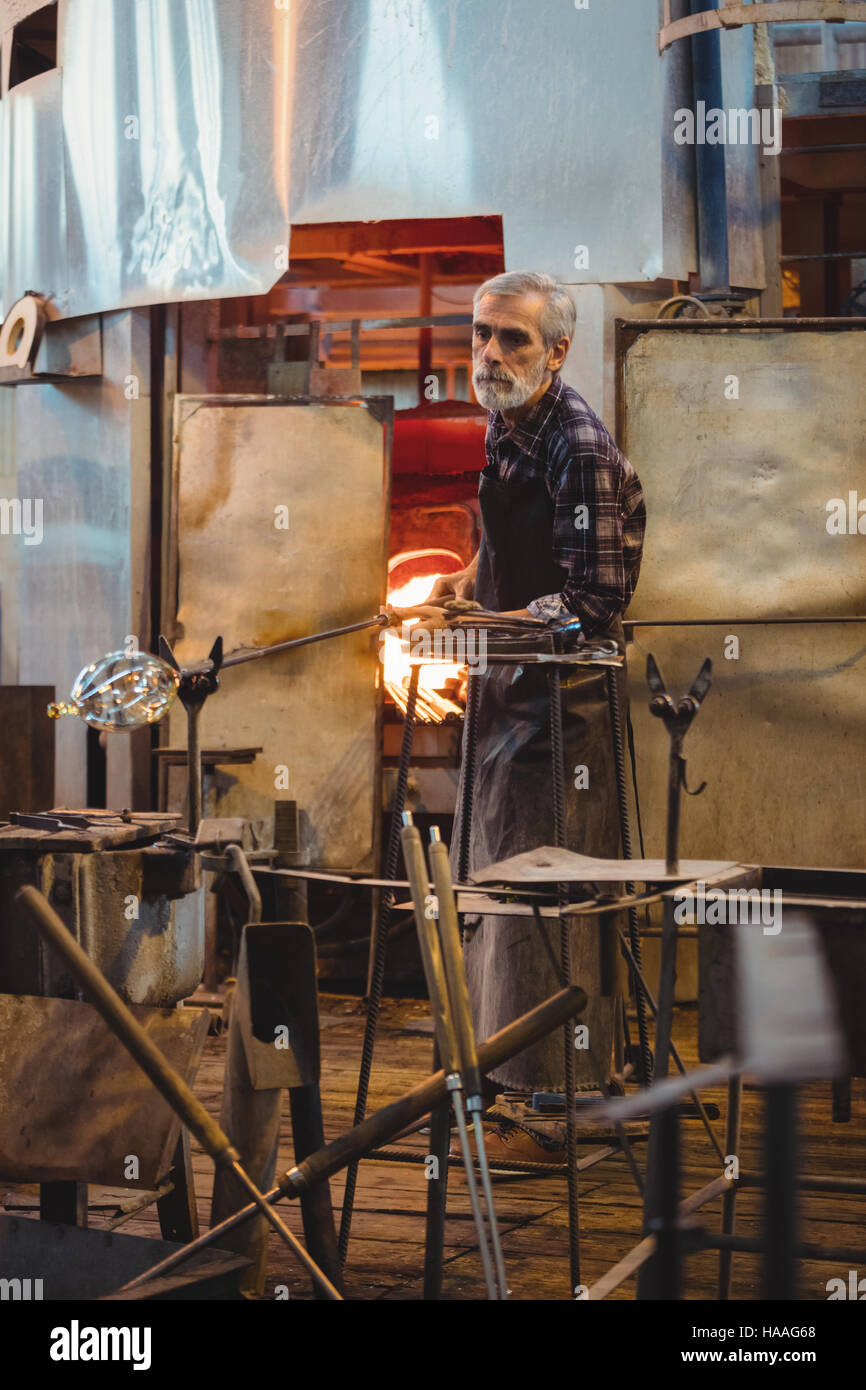 Glassblower shaping a molten glass Stock Photo - Alamy