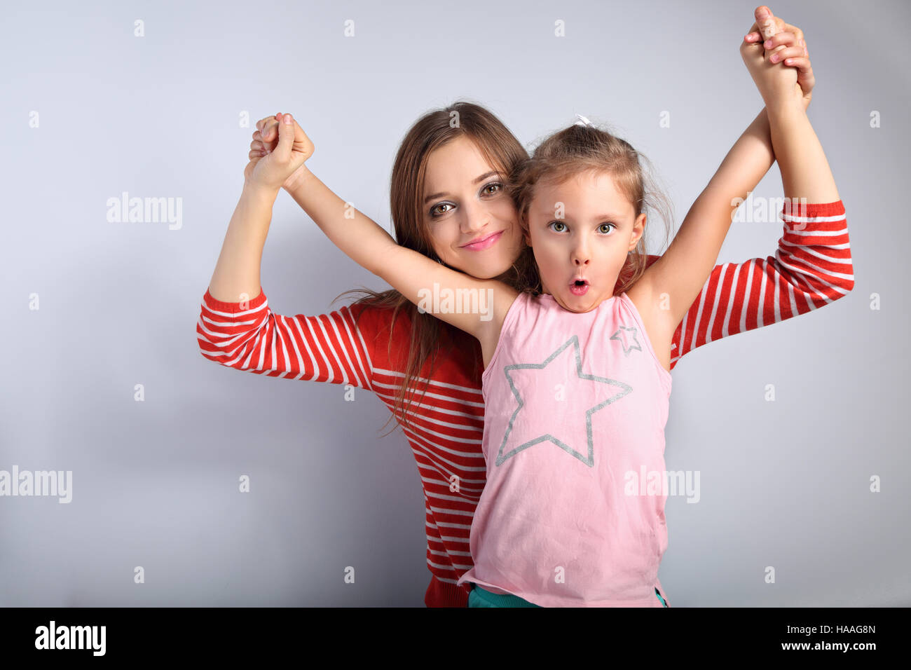 Playful mother and crazy joking grimacing kid holding each other by the ...
