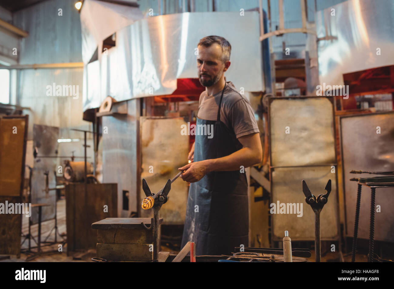 Glassblower shaping a molten glass Stock Photo - Alamy