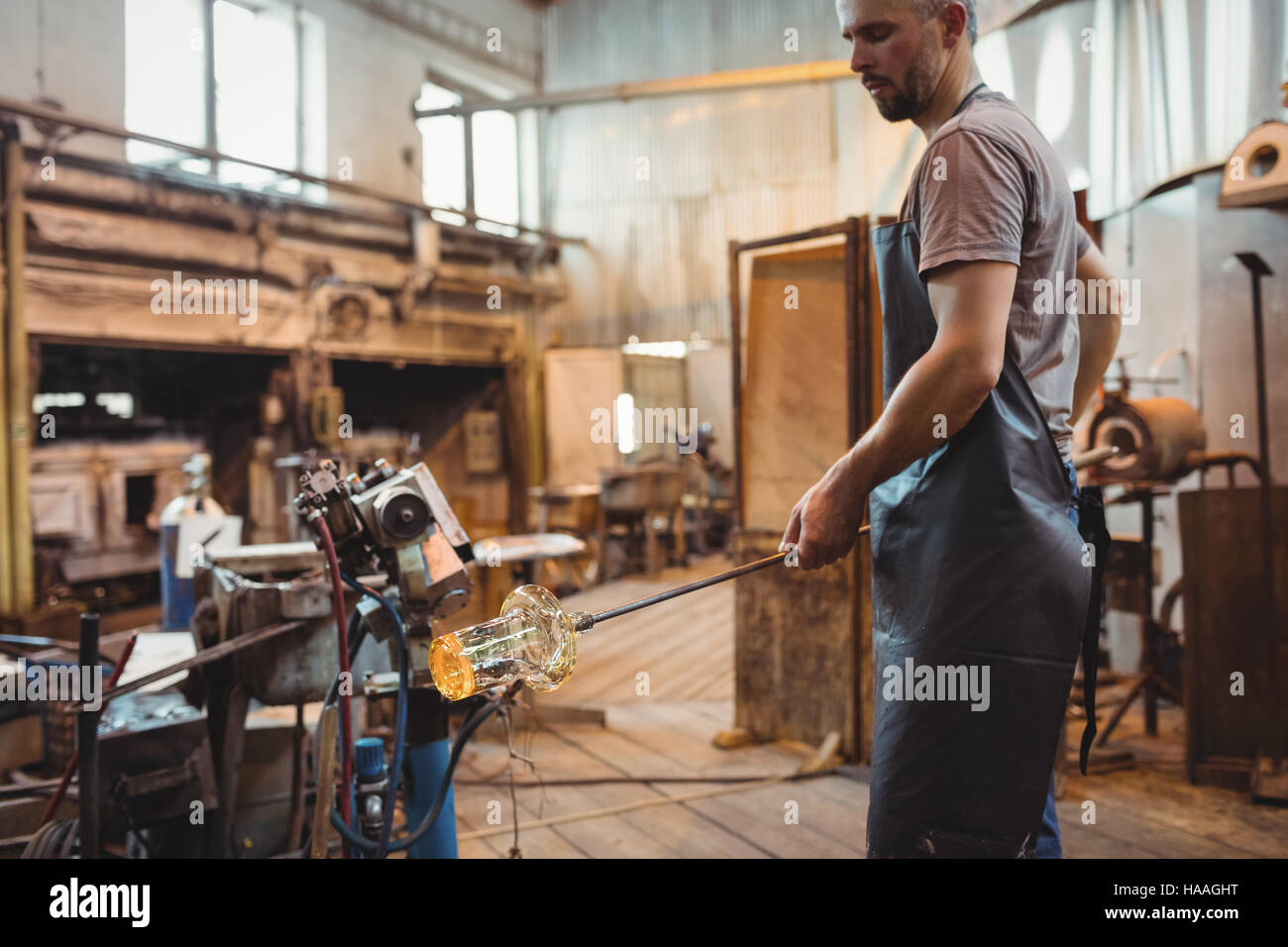 Glassblower shaping a molten glass Stock Photo - Alamy