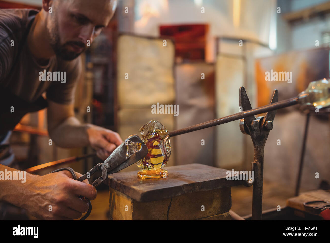 Glassblower shaping a molten glass Stock Photo - Alamy