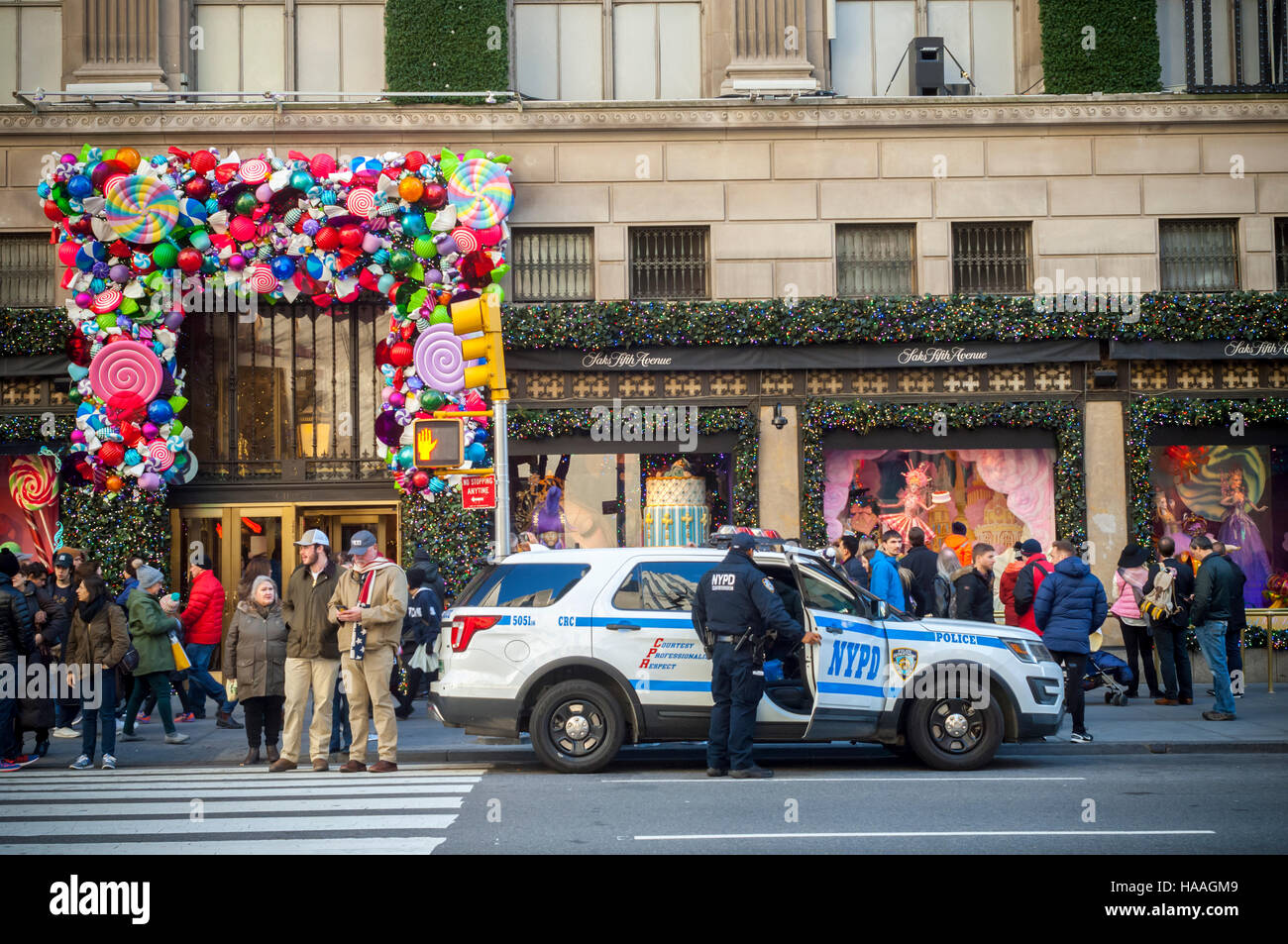 NYPD officers in front of the holiday decorations on Saks Fifth Avenue ...