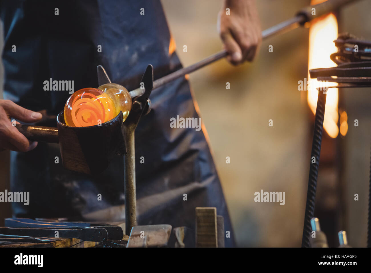 Glassblower forming and shaping a molten glass Stock Photo - Alamy
