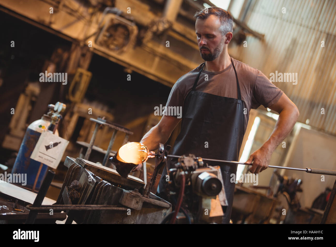 Glassblower forming and shaping a molten glass Stock Photo - Alamy