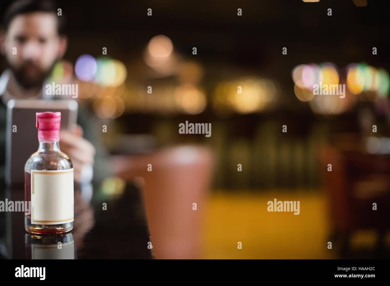 Small liquor bottle on table Stock Photo - Alamy