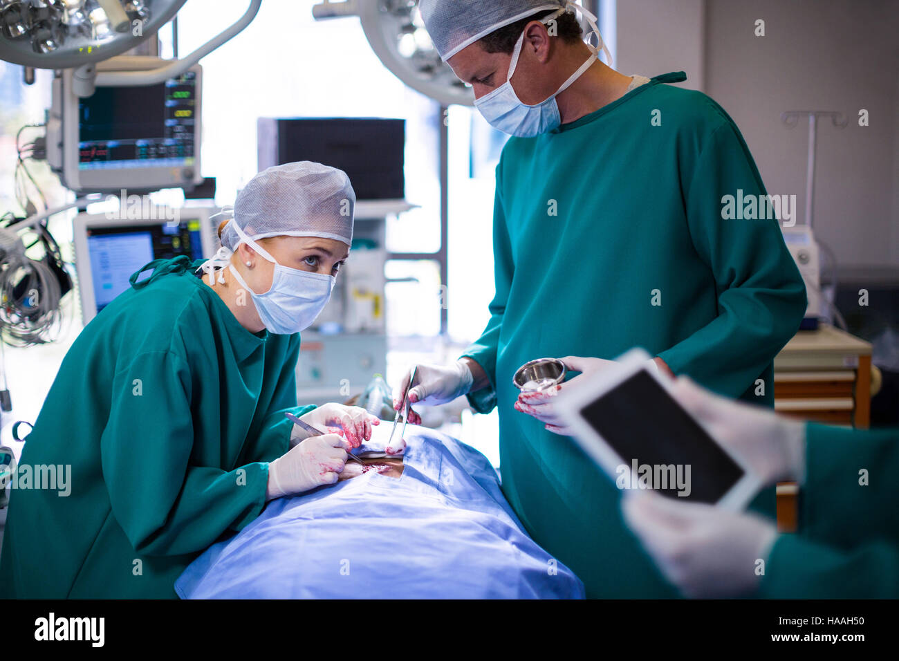 Surgeons performing operation in operation theater Stock Photo - Alamy
