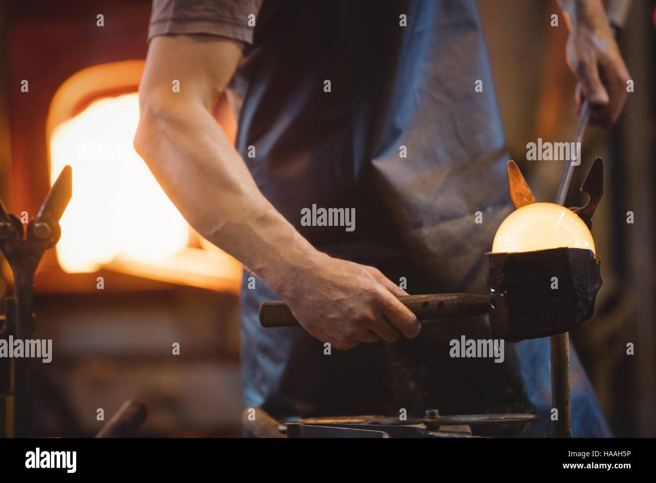 Glassblower forming and shaping a molten glass Stock Photo - Alamy