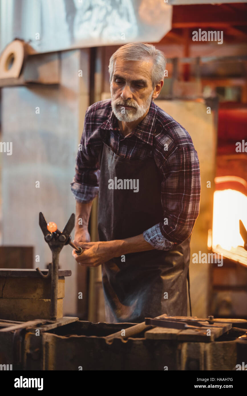 Glassblower shaping a molten glass Stock Photo - Alamy