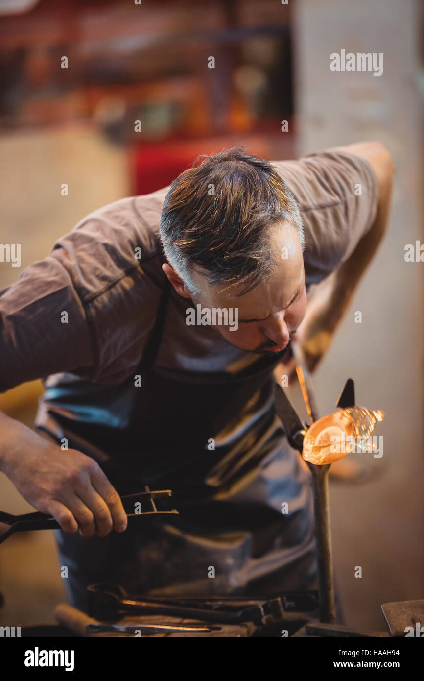 Glassblower shaping a molten glass Stock Photo - Alamy