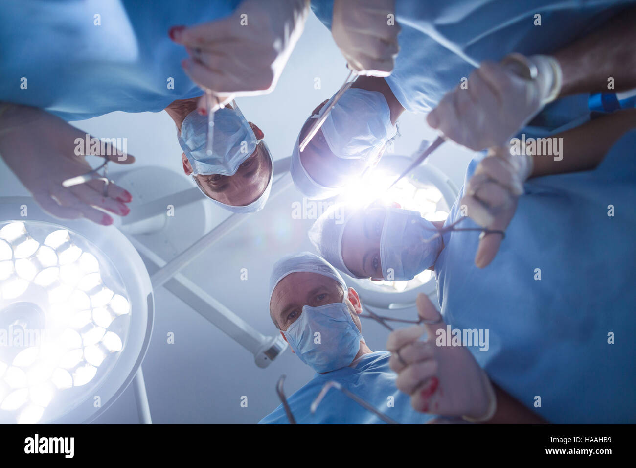 Group of surgeons performing operation in operation room Stock Photo ...