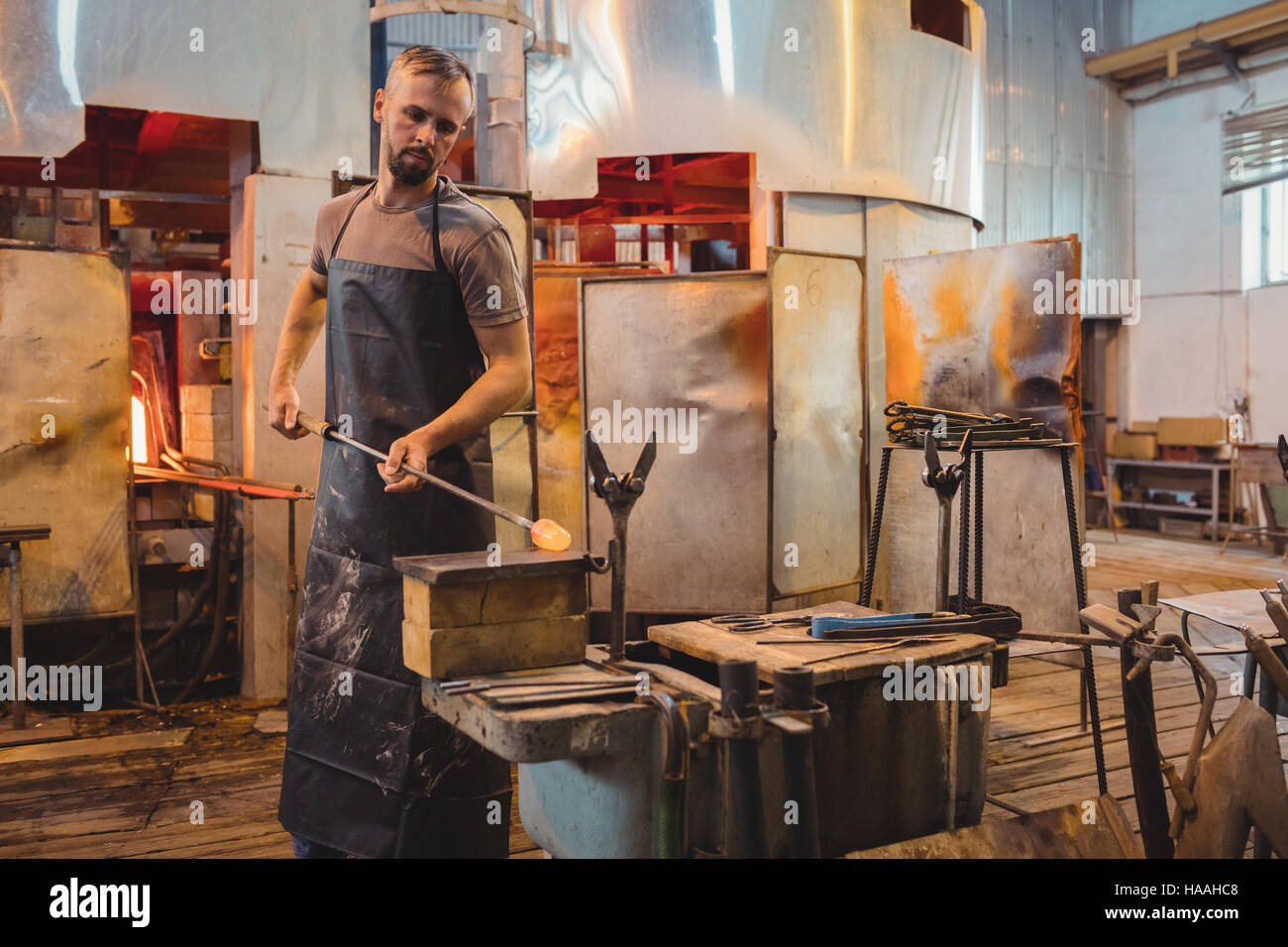 Glassblower shaping a molten glass Stock Photo - Alamy