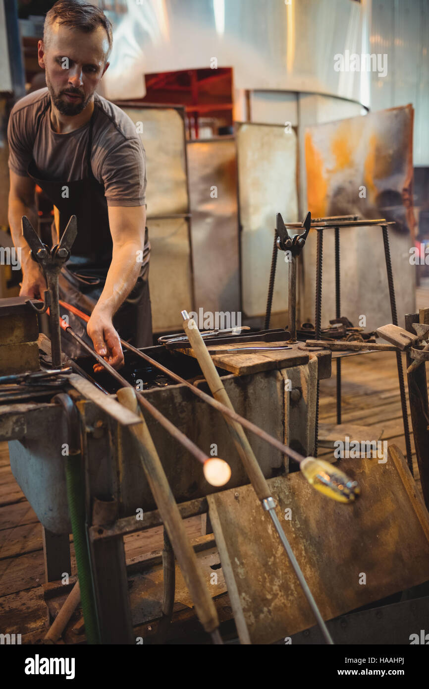 Glassblower shaping a molten glass Stock Photo - Alamy