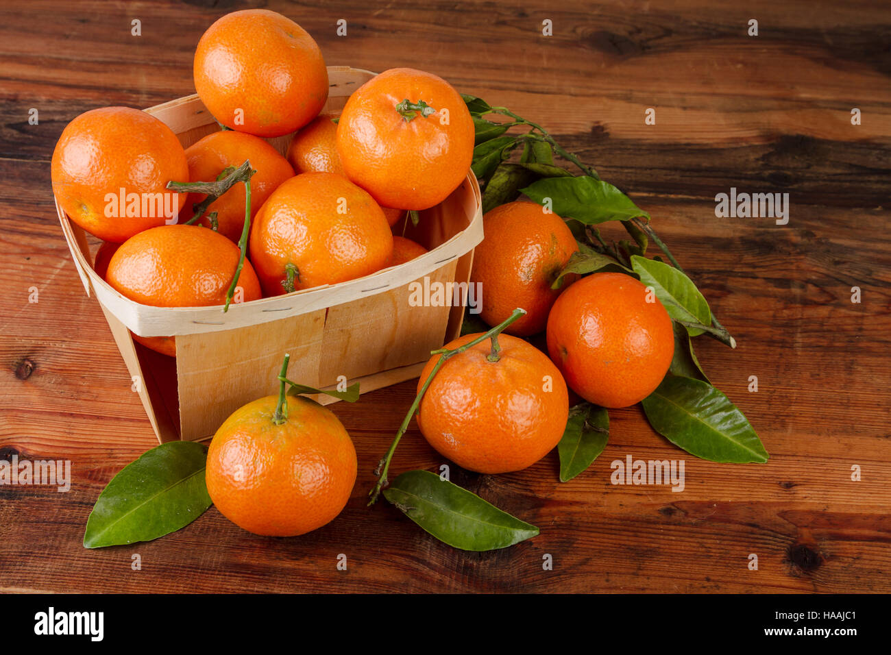 tangerines organic fruits with leaves on wooden background Stock Photo ...