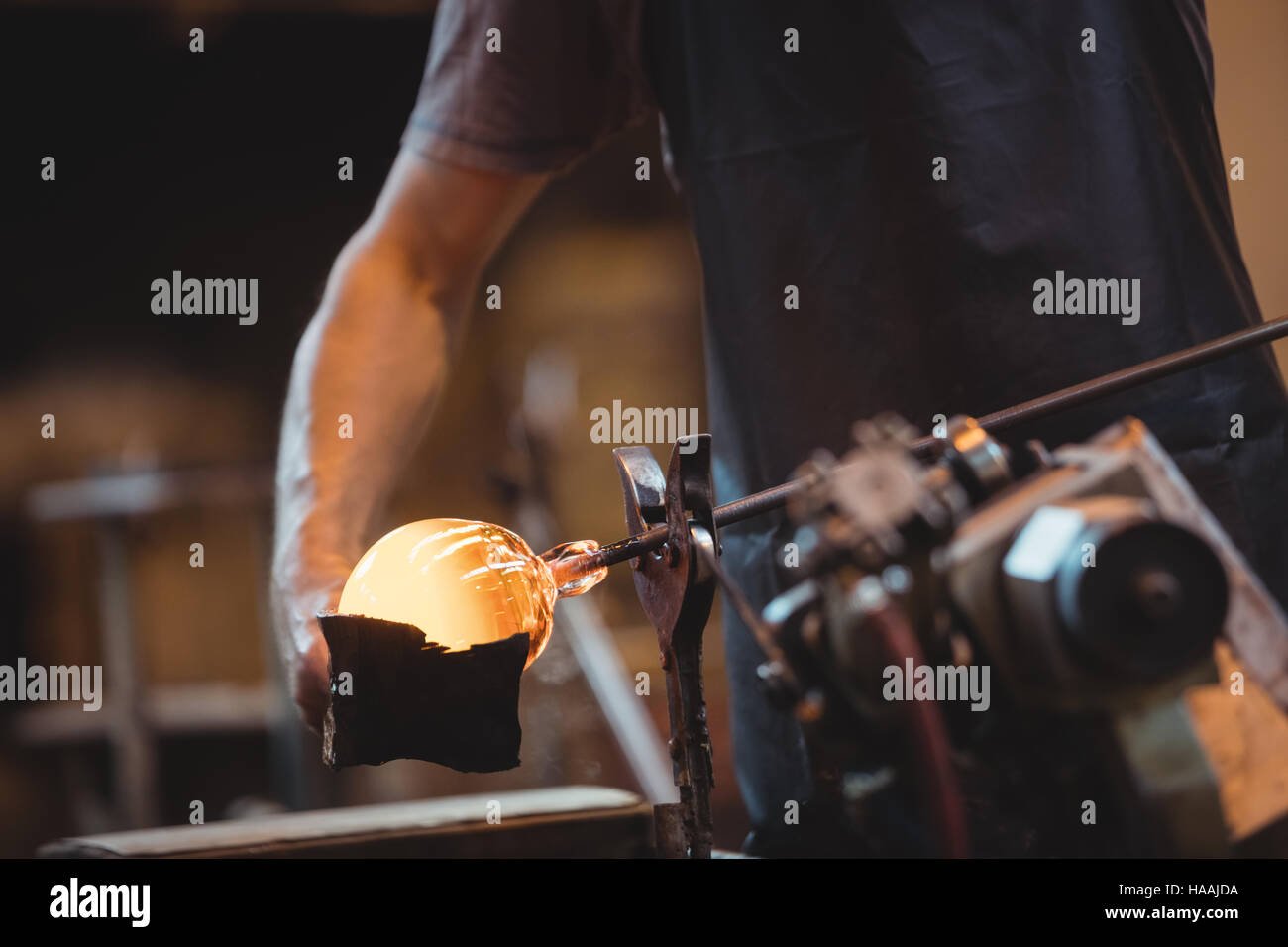 Glassblower forming and shaping a molten glass Stock Photo - Alamy