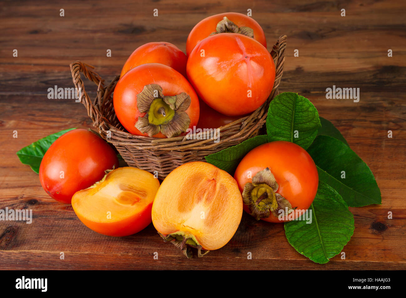 persimmon fruits in a basket Stock Photo - Alamy