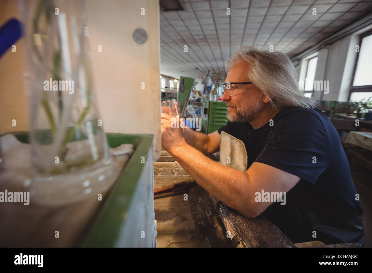 Glassblower polishing and grinding a glassware Stock Photo - Alamy