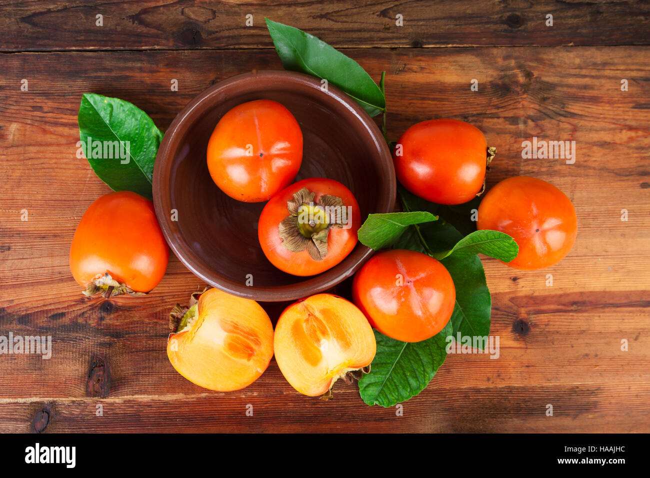 Persimmons kaki fruits on rustic table. Top view Stock Photo - Alamy