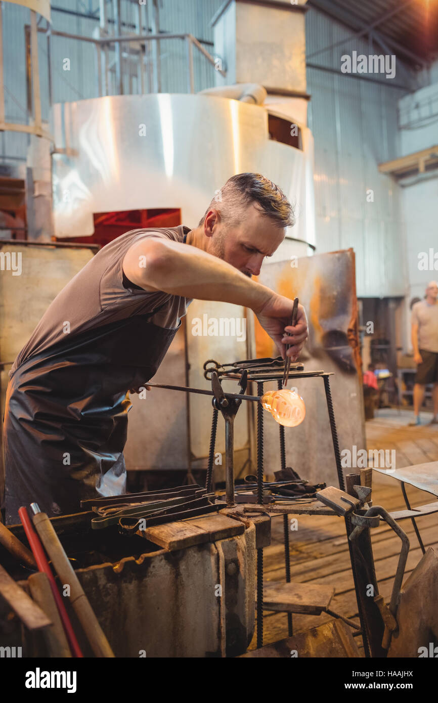 Glassblower shaping a molten glass Stock Photo - Alamy