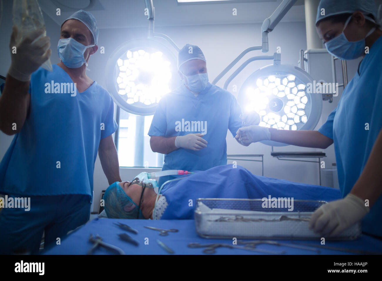 Group of surgeons performing operation in operation room Stock Photo ...