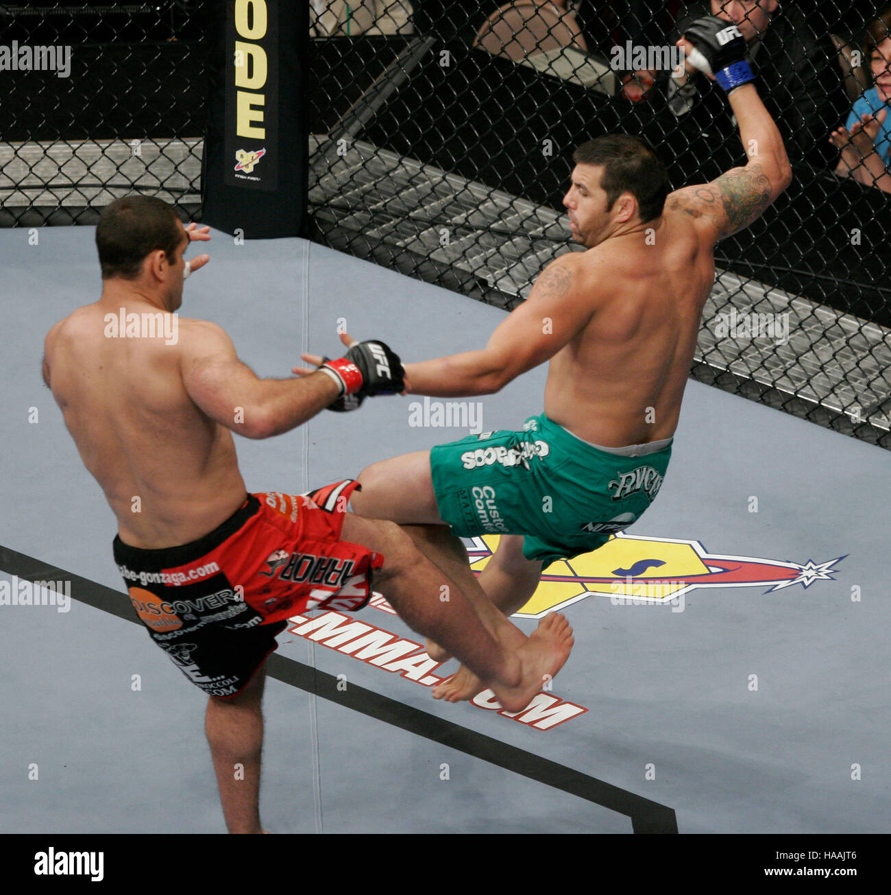 Gabriel Gonzaga (red shorts) fights Justin McCully, (green shorts ...