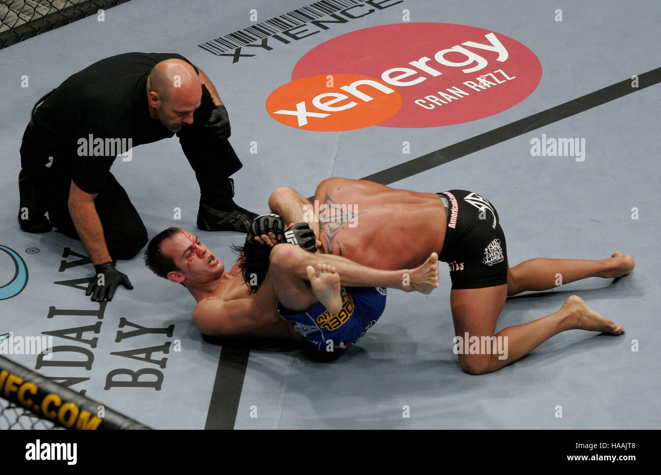 Cole Miller, left, applies a triangle choke to Jorge Gurgel during UFC ...