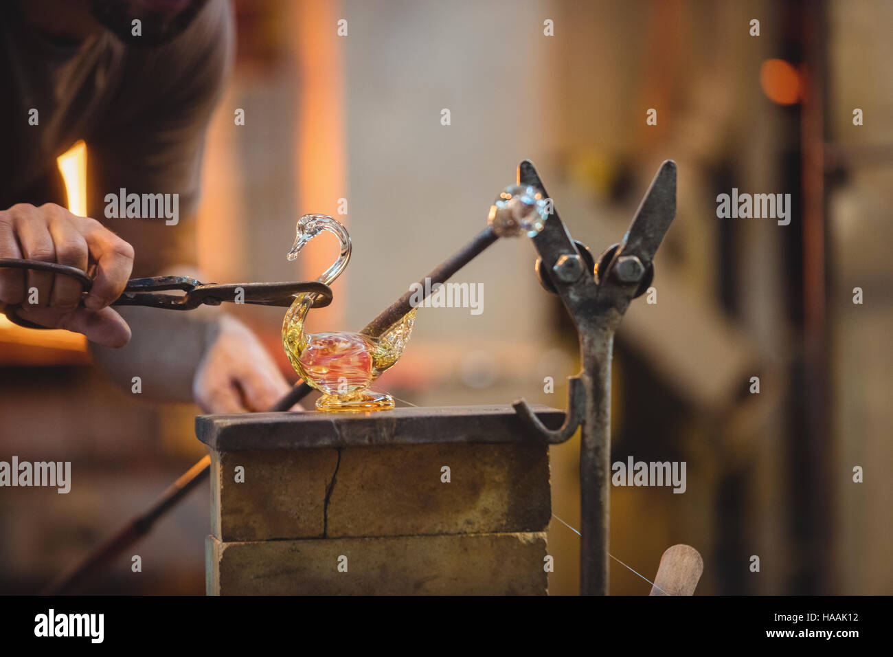 Glassblower shaping a molten glass Stock Photo - Alamy