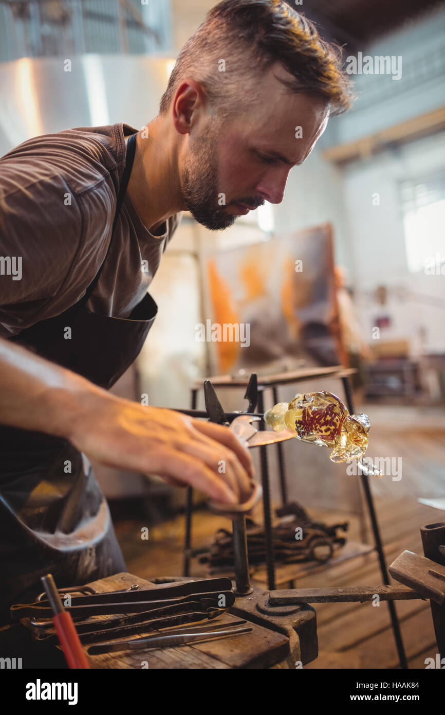 Glassblower shaping a molten glass Stock Photo - Alamy