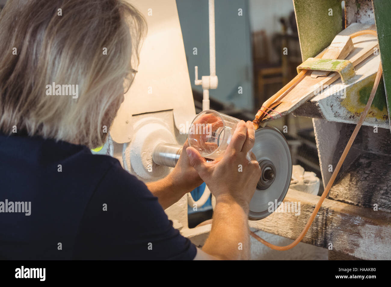 Glassblower polishing and grinding a glassware Stock Photo - Alamy