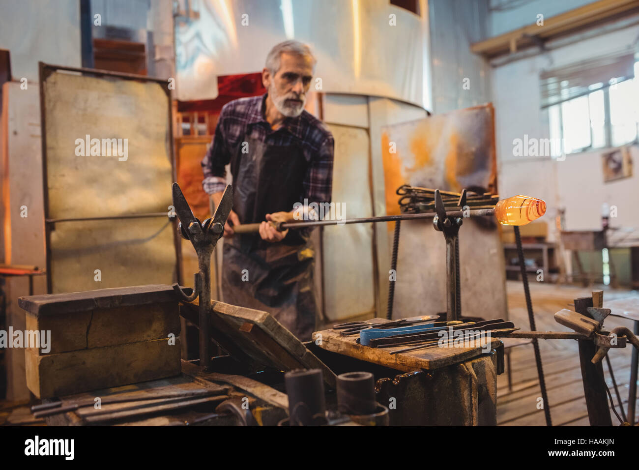 Glassblower shaping a molten glass Stock Photo - Alamy