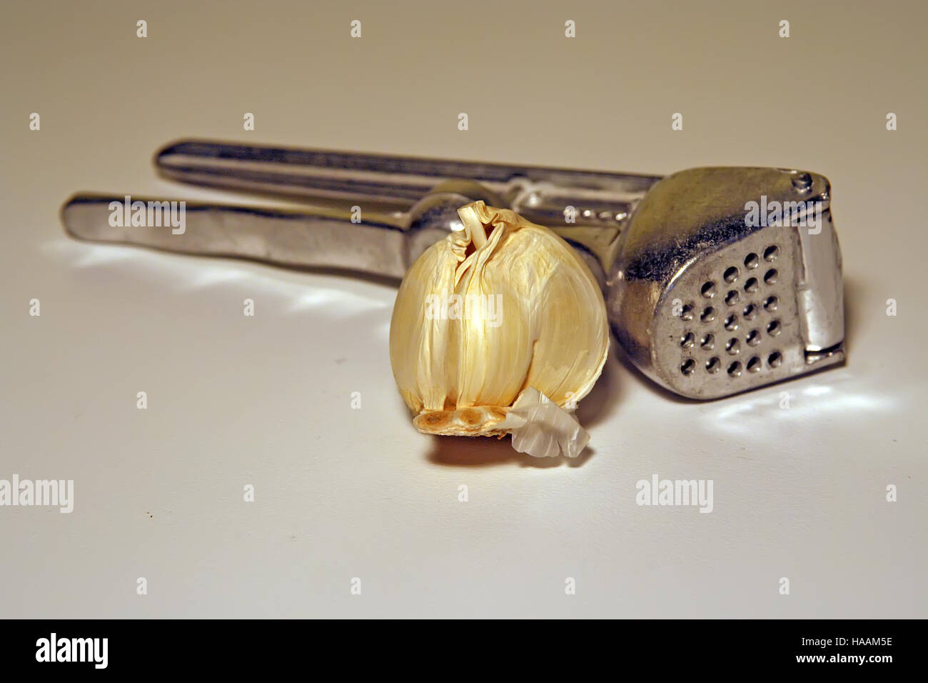 Garlic squasher. Kitchen tool. Garlic mashing tool Stock Photo - Alamy