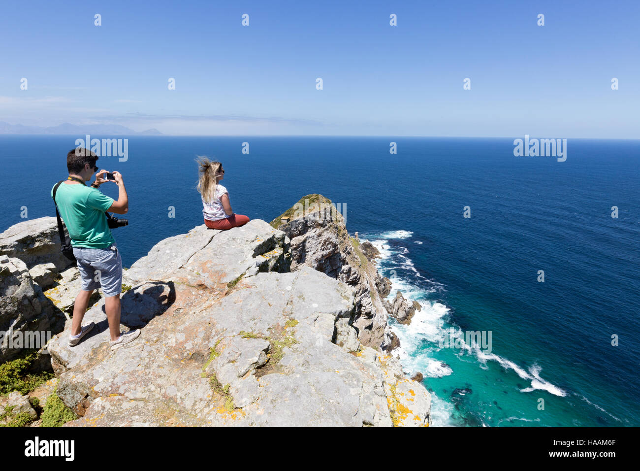 A tourist couple taking photos at Cape Point, Cape Peninsula, Cape Town ...