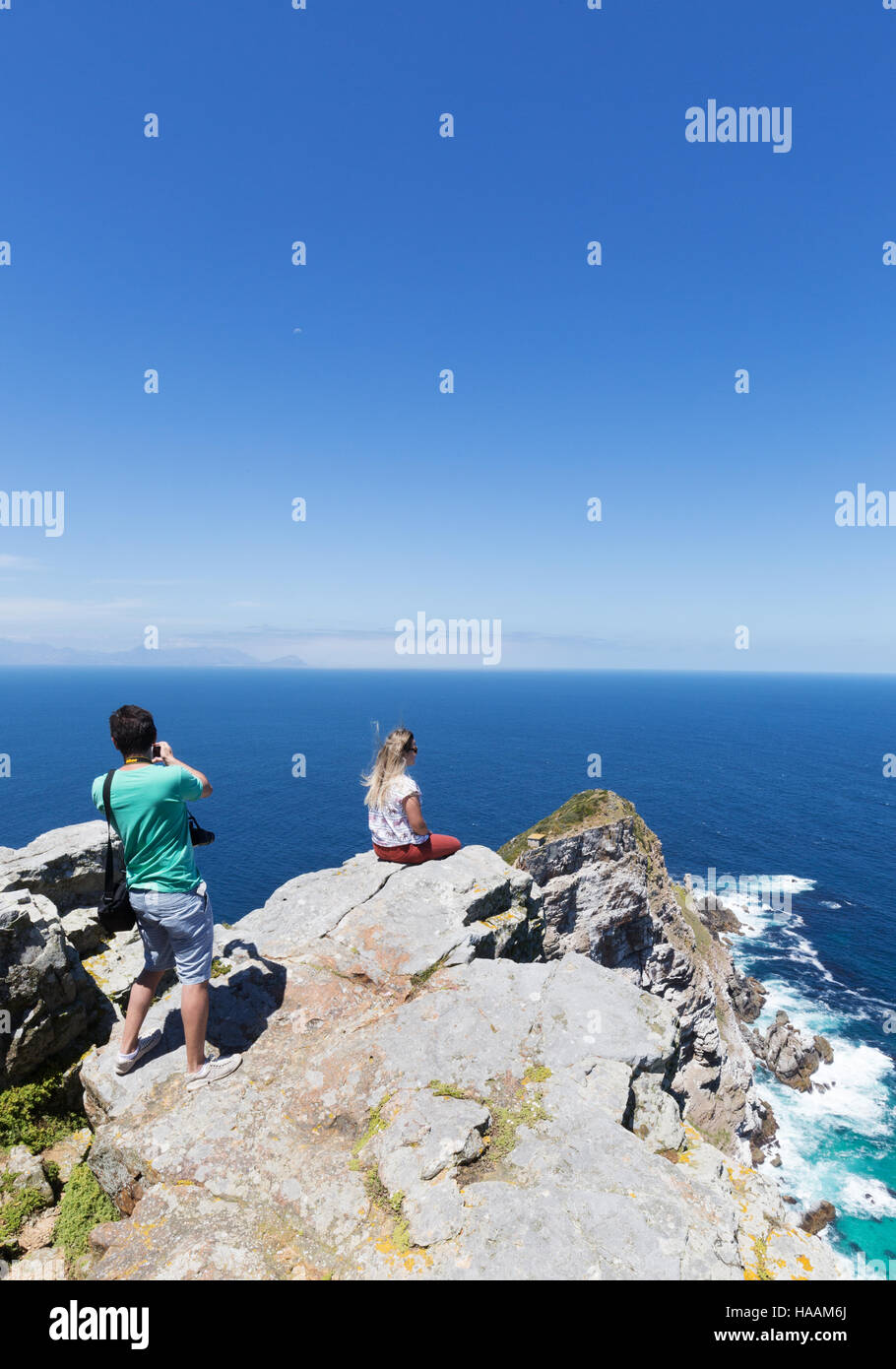 A tourist couple taking photos at Cape Point, Cape Peninsula, Cape Town ...