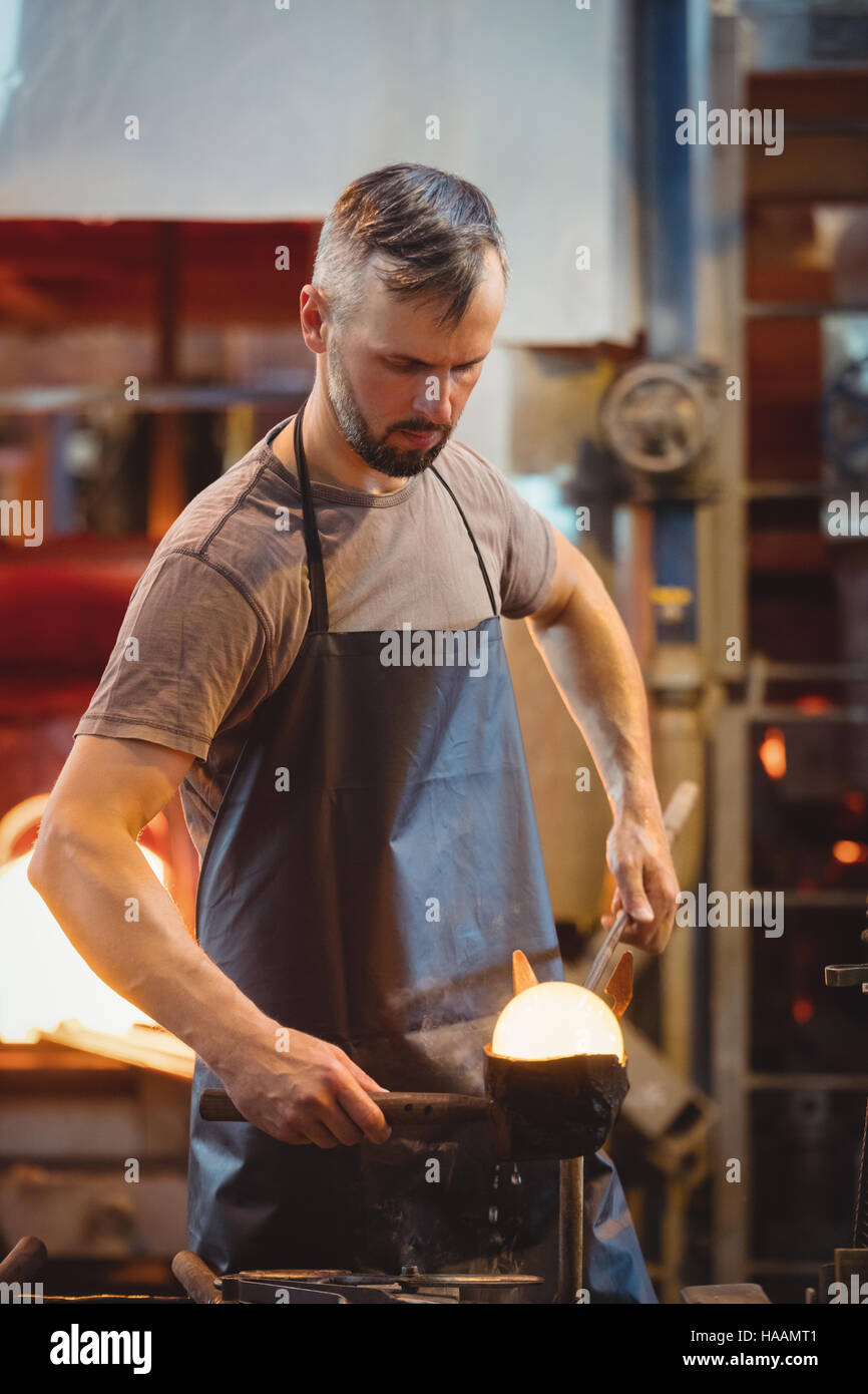 Glassblower forming and shaping a molten glass Stock Photo - Alamy