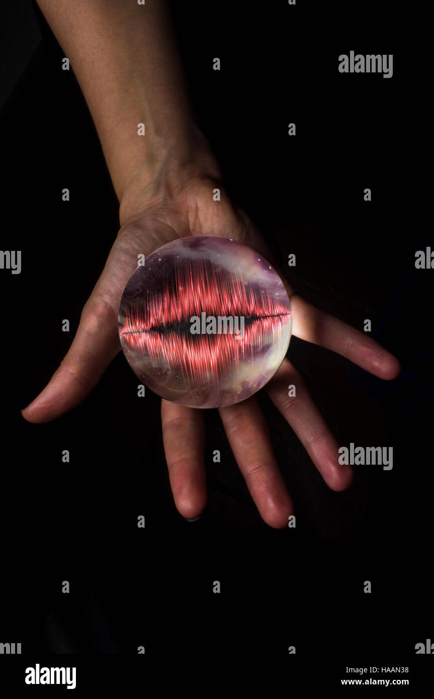 Hands holding crystal ball containing sound wave Stock Photo - Alamy