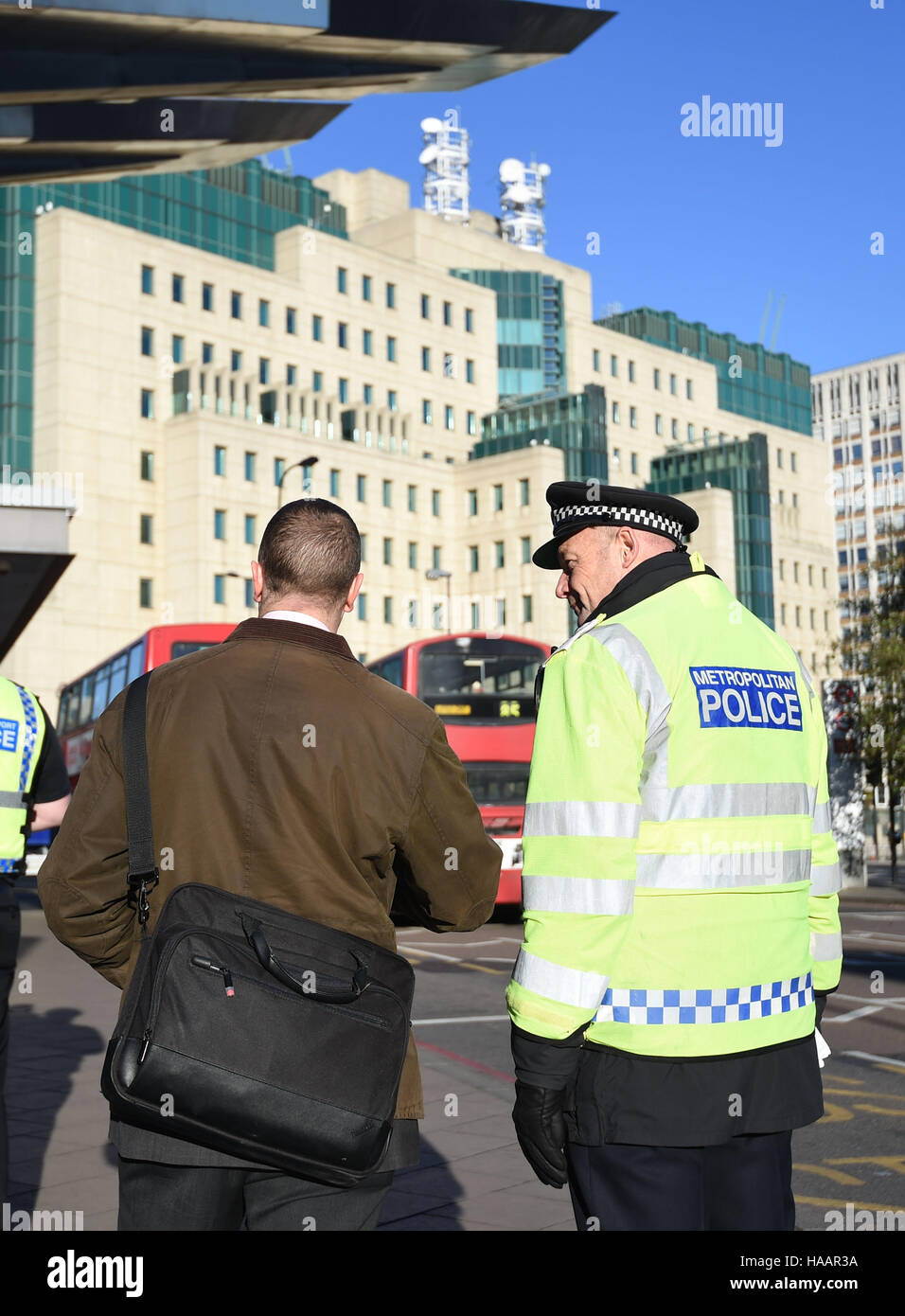 A police officer speaks to a commuter in front of the Secret ...