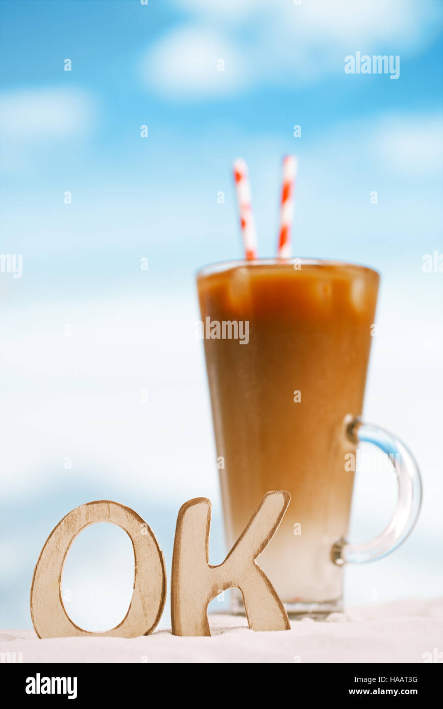 word OK with iced coffee latte on a beach ocean and seascape Stock ...